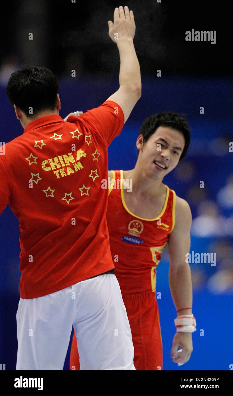 Zou Kai of China reacts after his performance, on his way to winning ...
