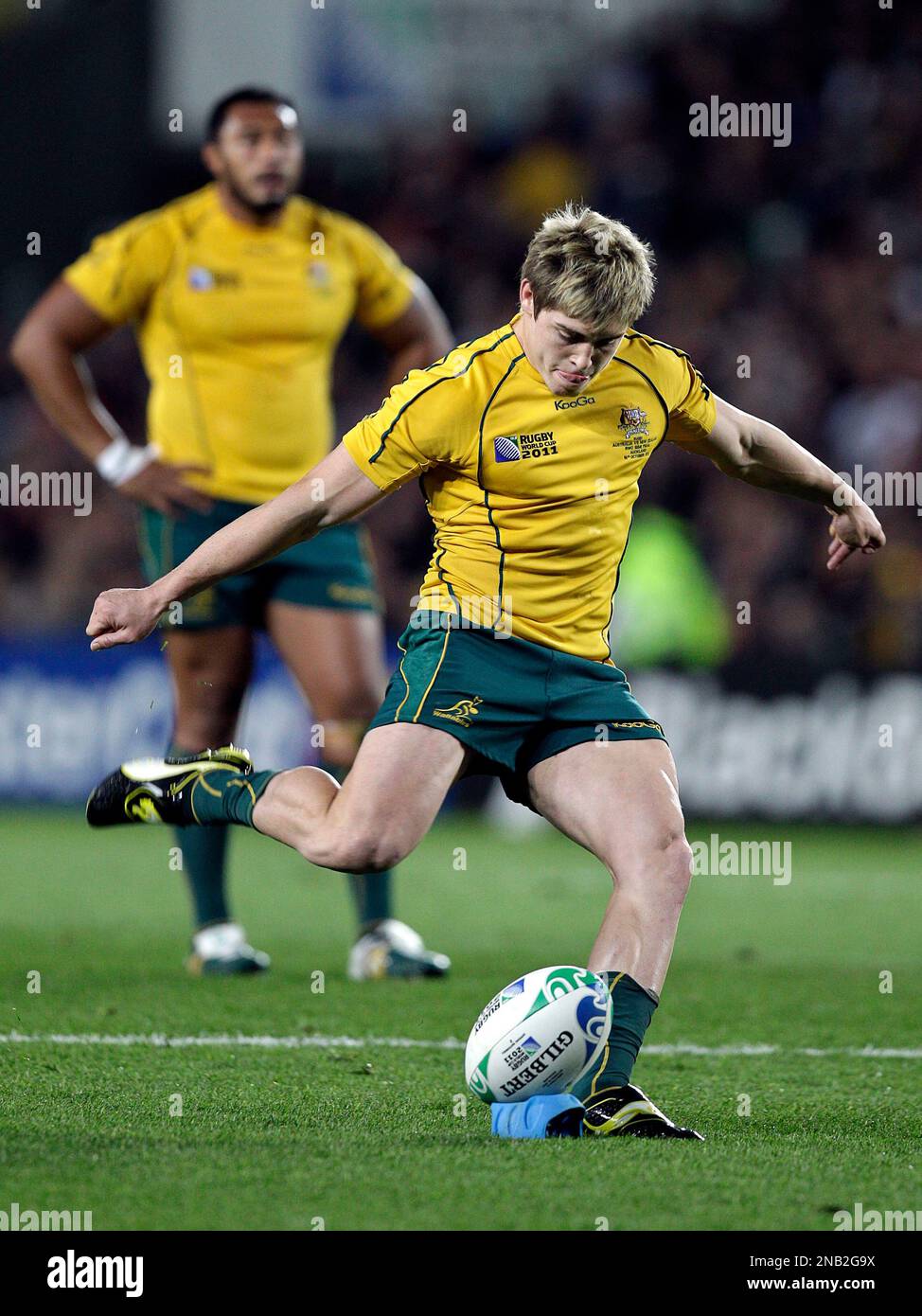 Australia's James O'Connor kicks the ball at goal as teammate Sekope ...