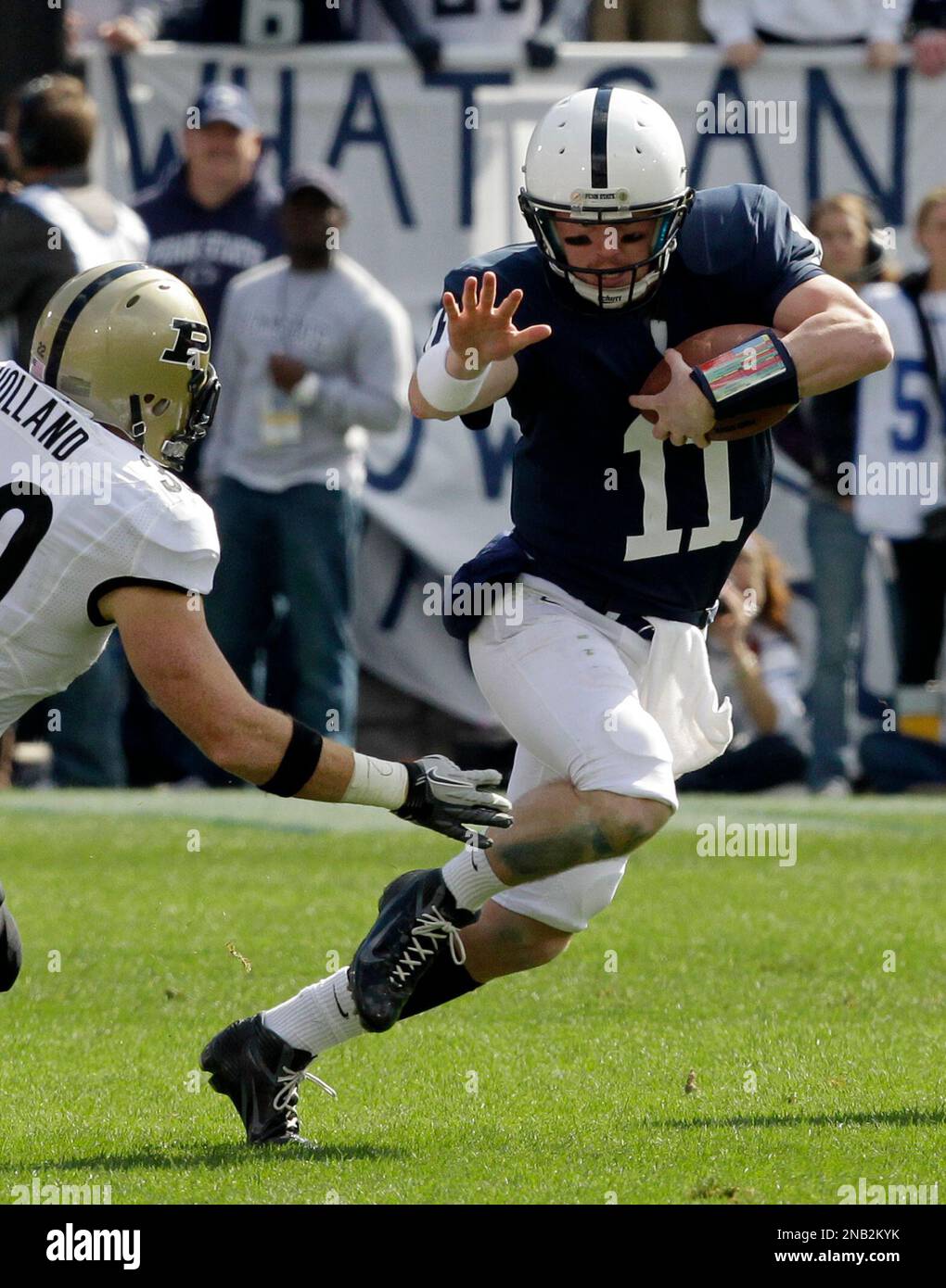 Penn State quarterback Matt McGloin (11) eludes the grasp of Purdue ...