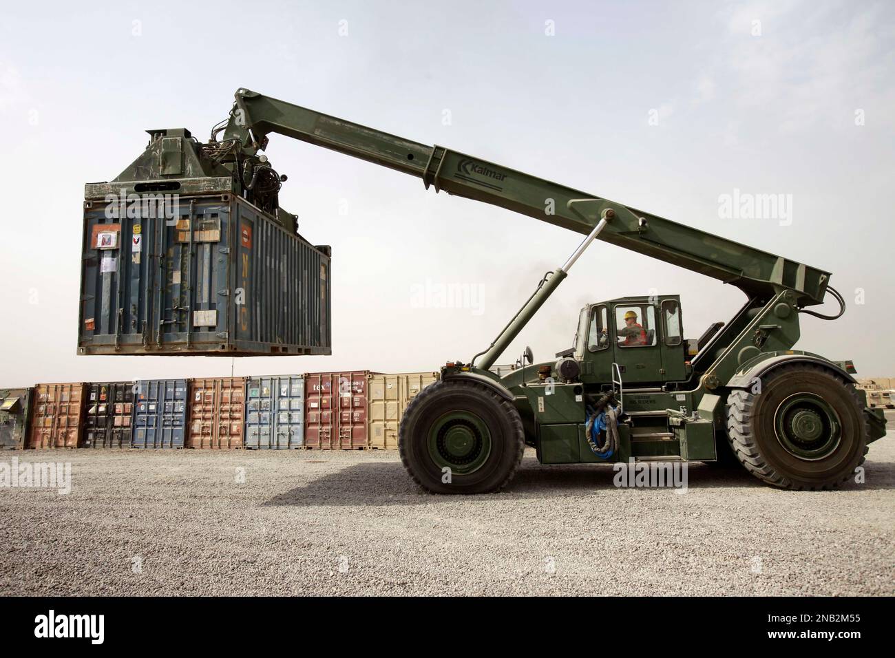 A U.S. army soldier transfers a container at Camp Sather, part of the ...