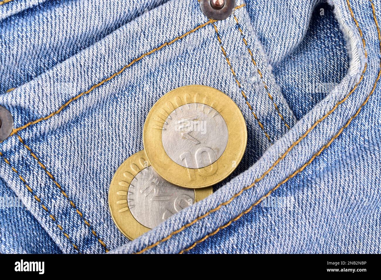 Saving money concept, coins in jeans pocket Stock Photo - Alamy