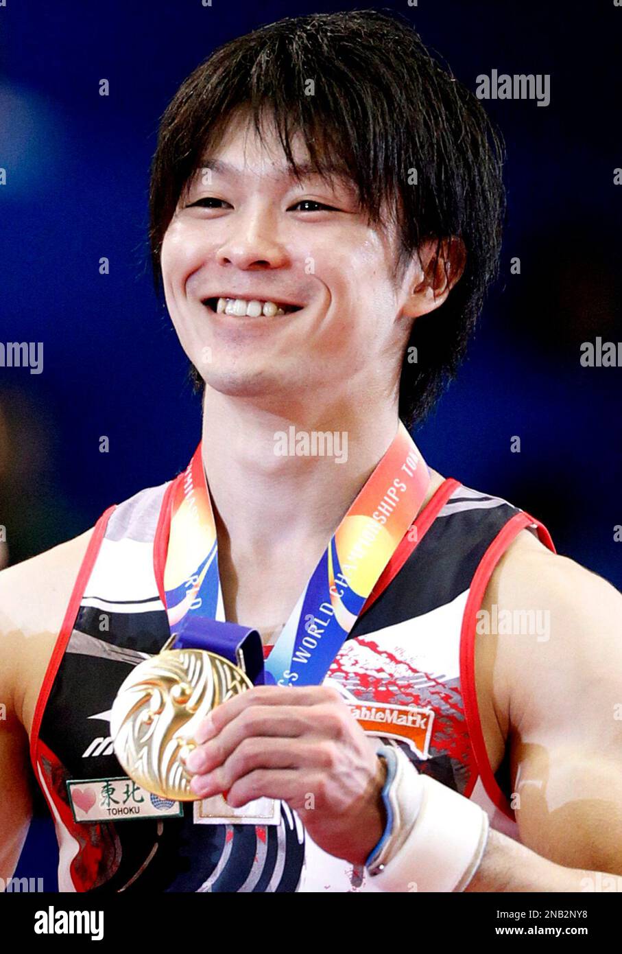Japan's Kohei Uchimura poses with the gold medal during the awarding ceremony for the final of ...