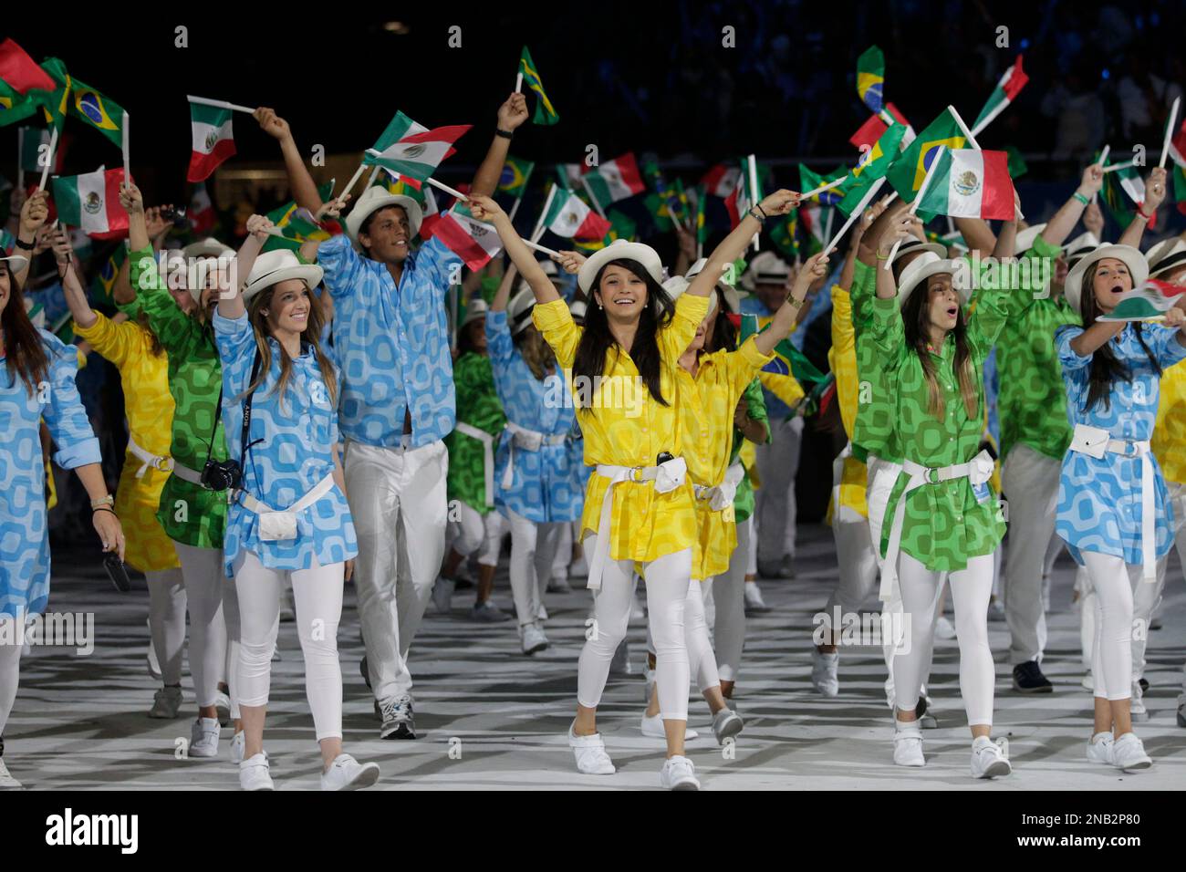 Waving Brazilian and Mexican flags, members of Brazil's team greet the ...
