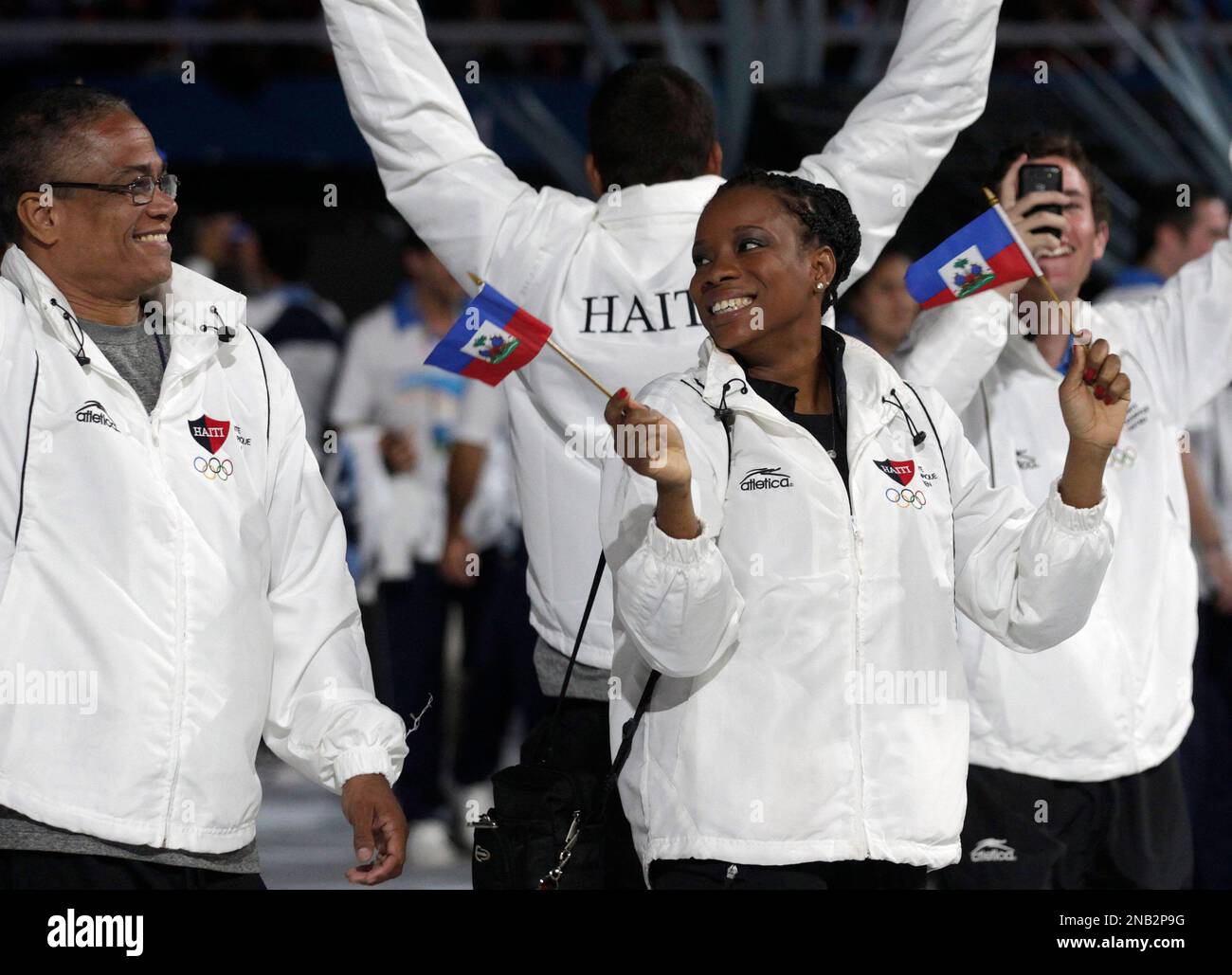 Haiti's team members smile as they parade during the opening ceremonies ...