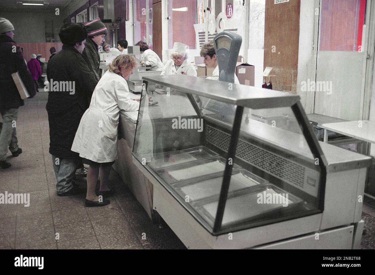 Soviet customers gather next to an empty display case as they purchase ...