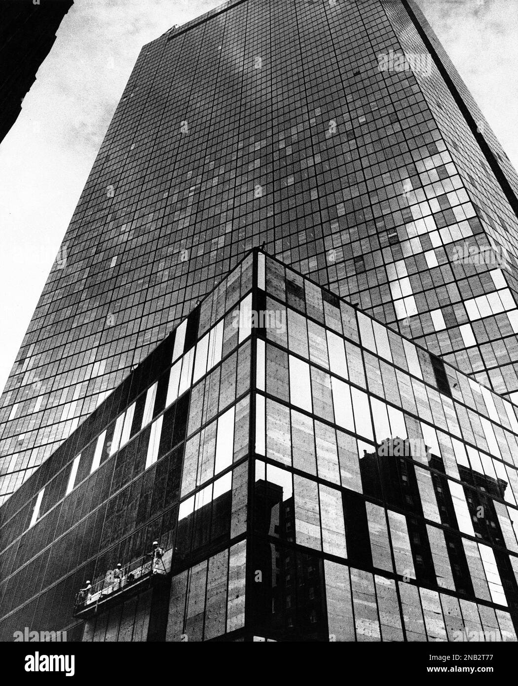 Workmen replace blown out panes of glass with plywood in Boston’s John ...