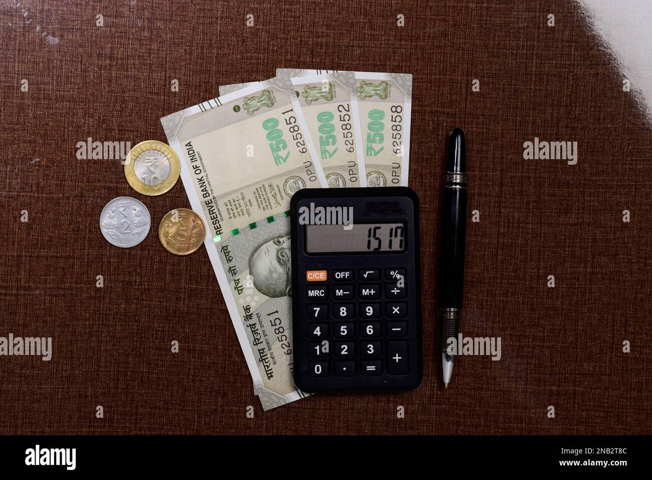 Indian currency note and coin with calculator Stock Photo - Alamy