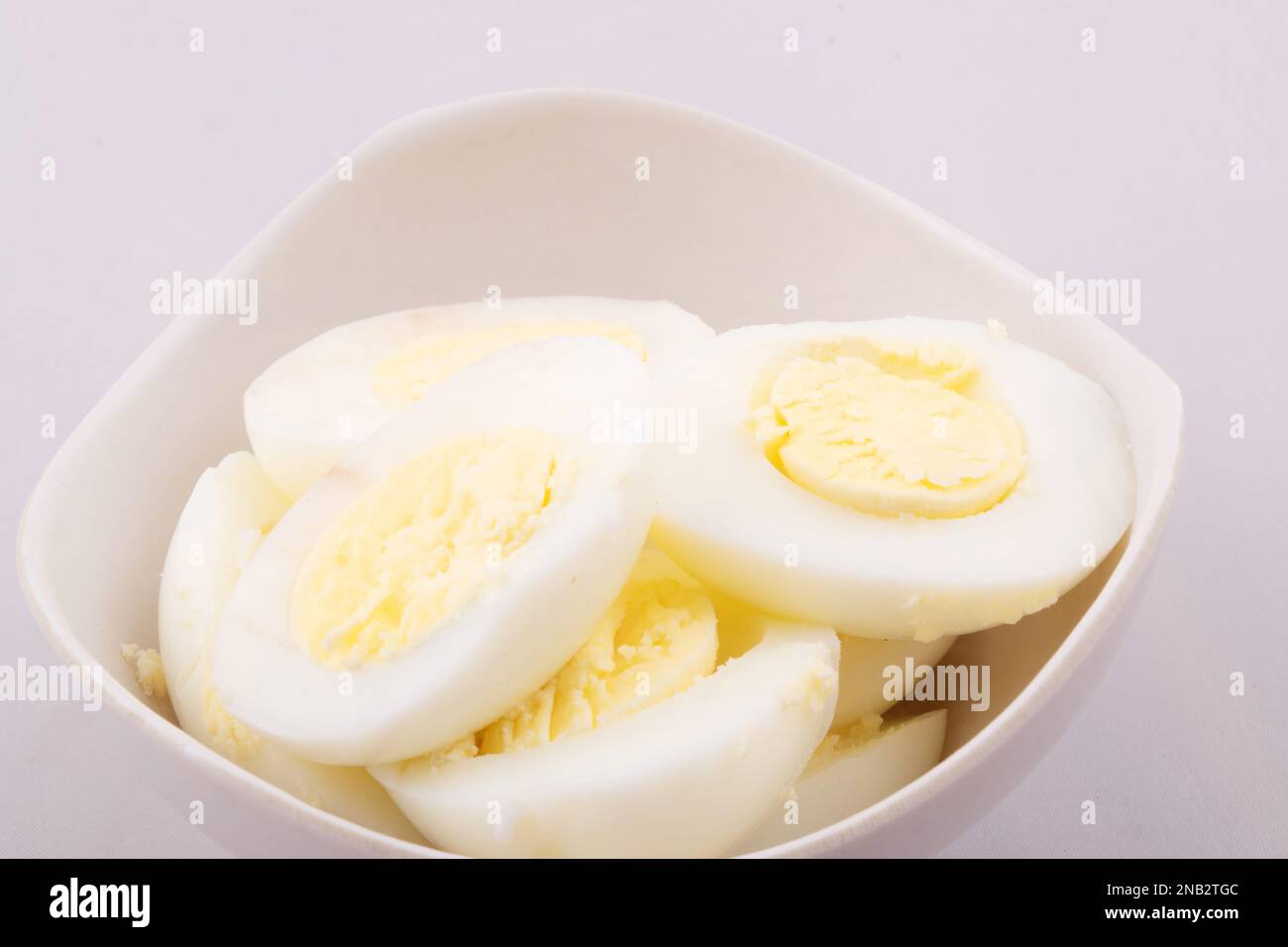 Boiled egg in bowl on white background Stock Photo - Alamy