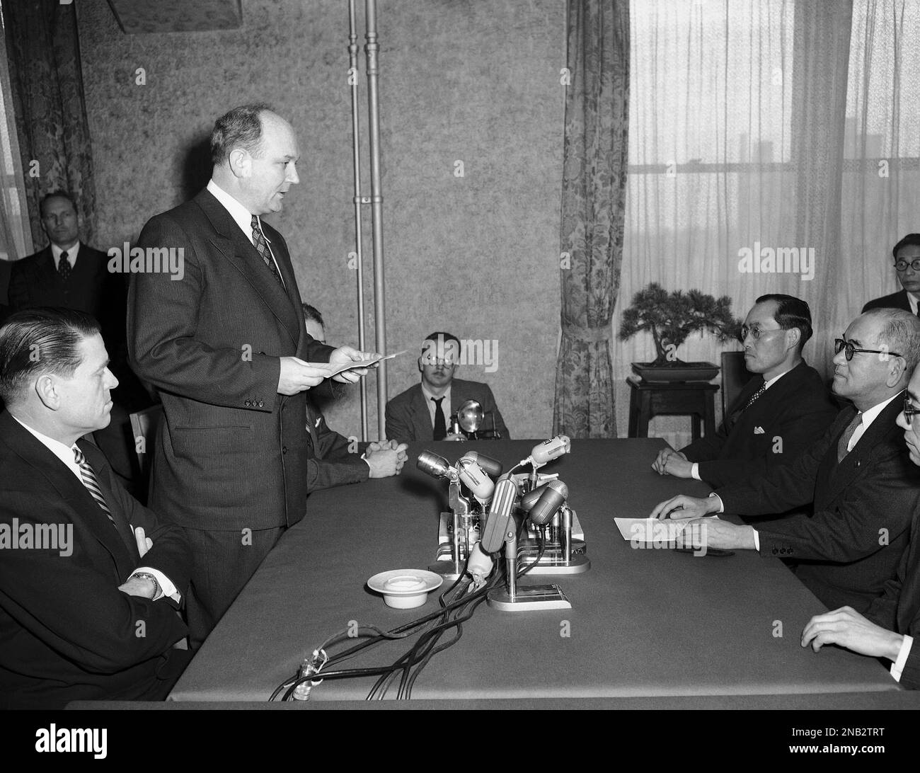 Ambassador Dean Rusk (left, standing) reading a prepared statement ...