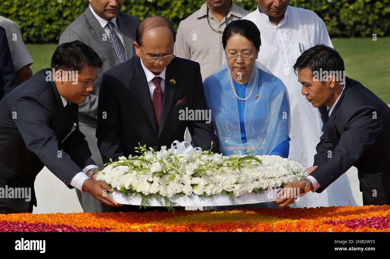 President of Myanmar Thein Sein, second left, and his wife Daw Khin Khin Win pay their respect ...