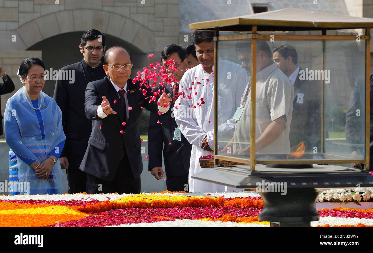 President of Myanmar Thein Sein showers flower petals on the memorial of Mahatma Gandhi as his ...