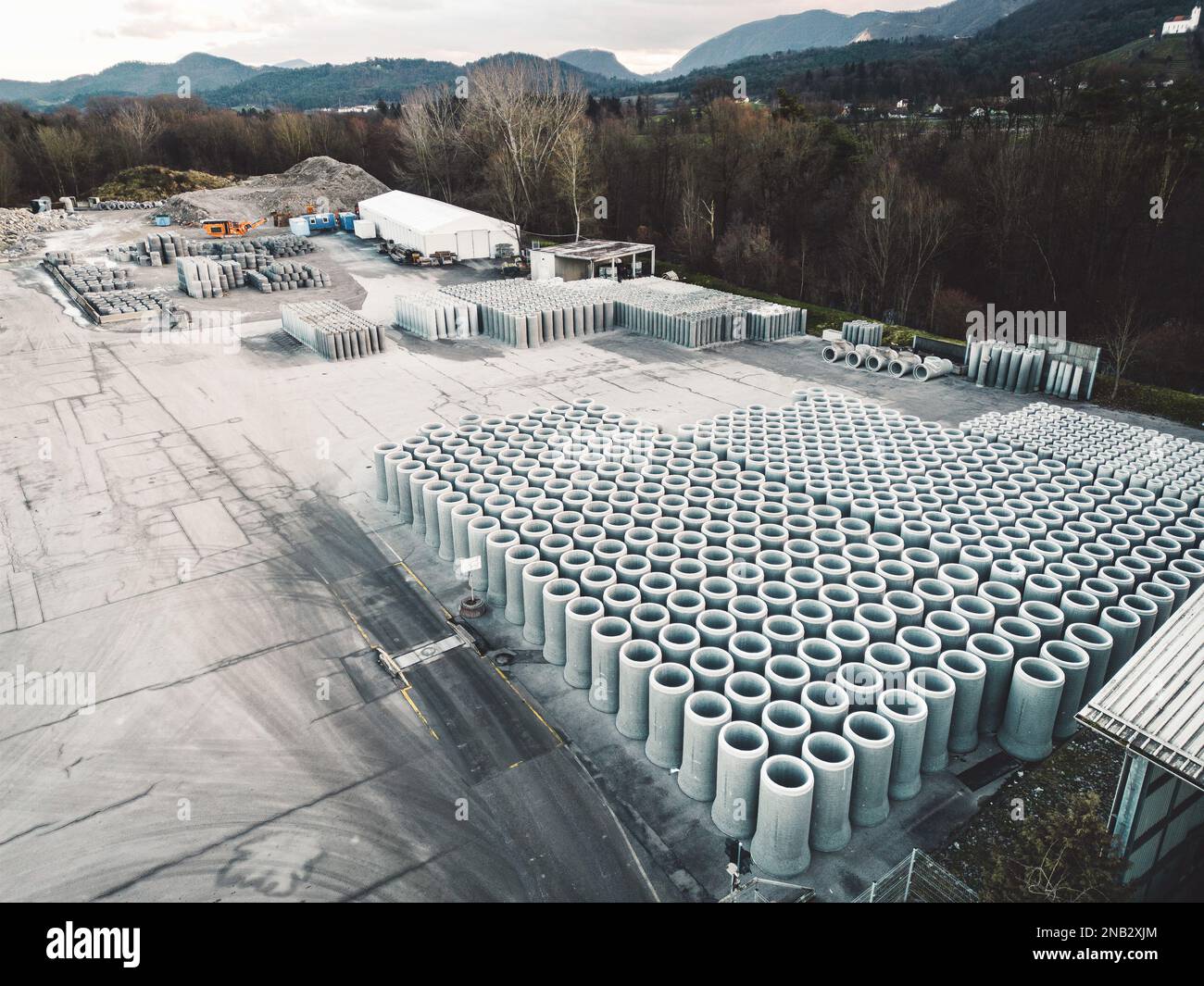 Aerial view at huge concrete pipes neatly stacked in rows at ...