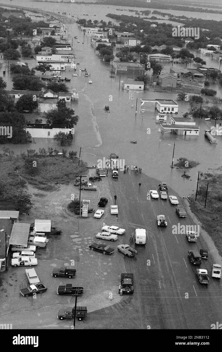 Rescue workers at the edge of water covering highway leading to the ...