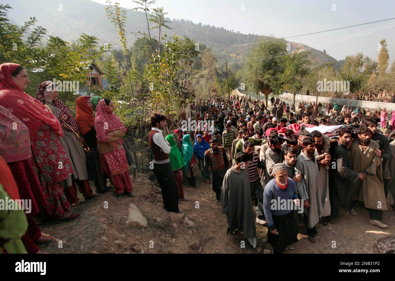 Kashmiri villagers carry the body of suspected militant Altaf Khan ...
