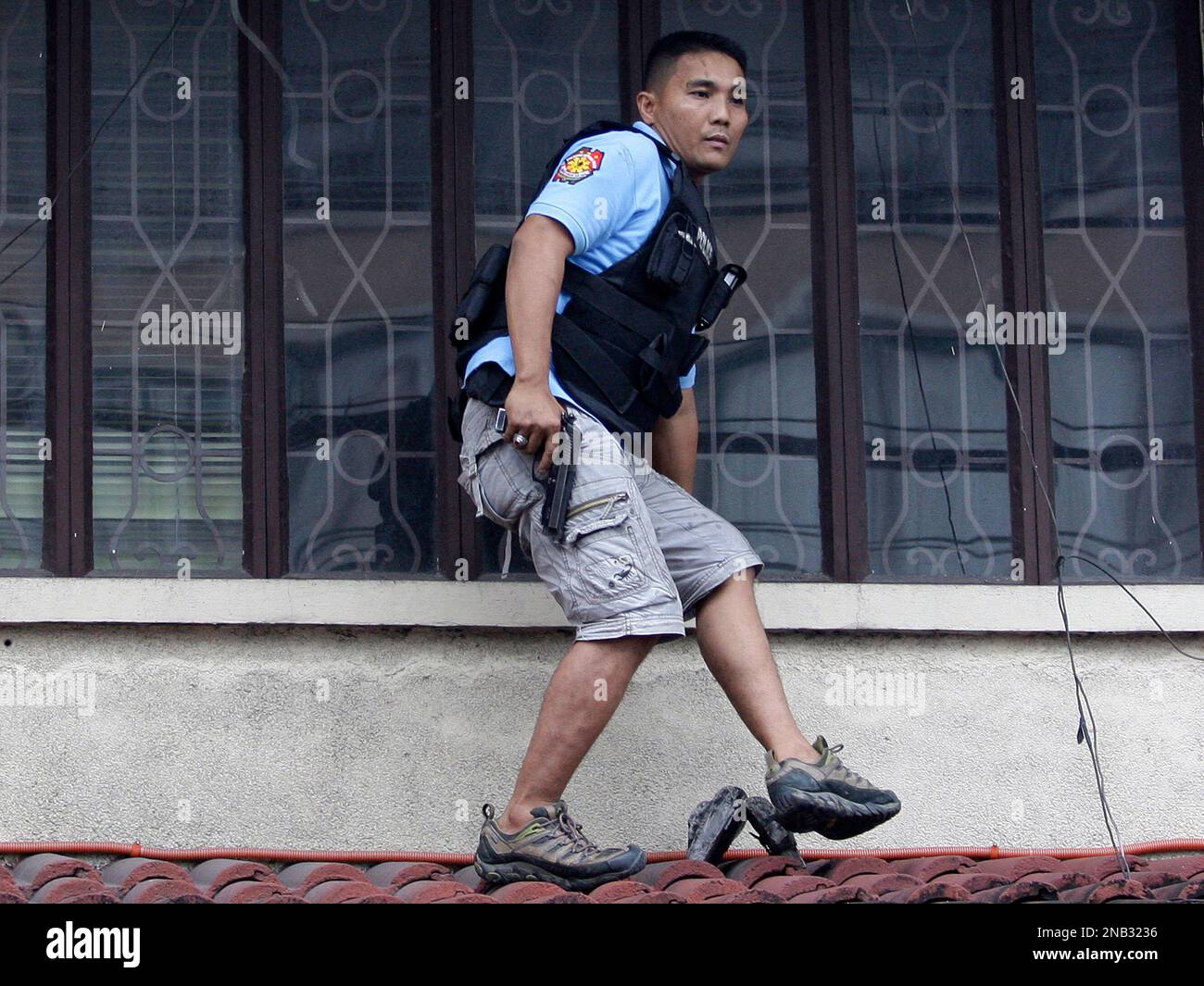 A policeman secures the area after hostages were released by captors ...