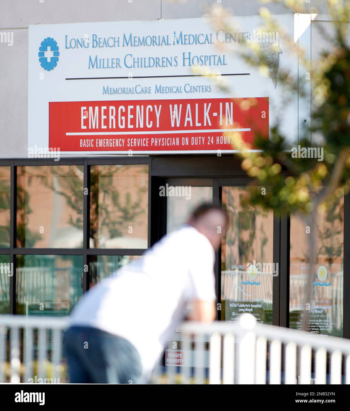 A man waits outside the emergency entrance at Long Beach Memorial where ...
