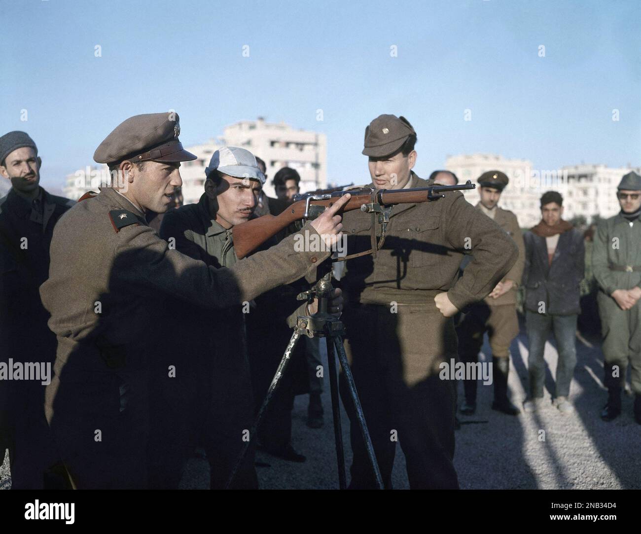 An officer of the Syrian army giving instructions on how to use a rifle ...