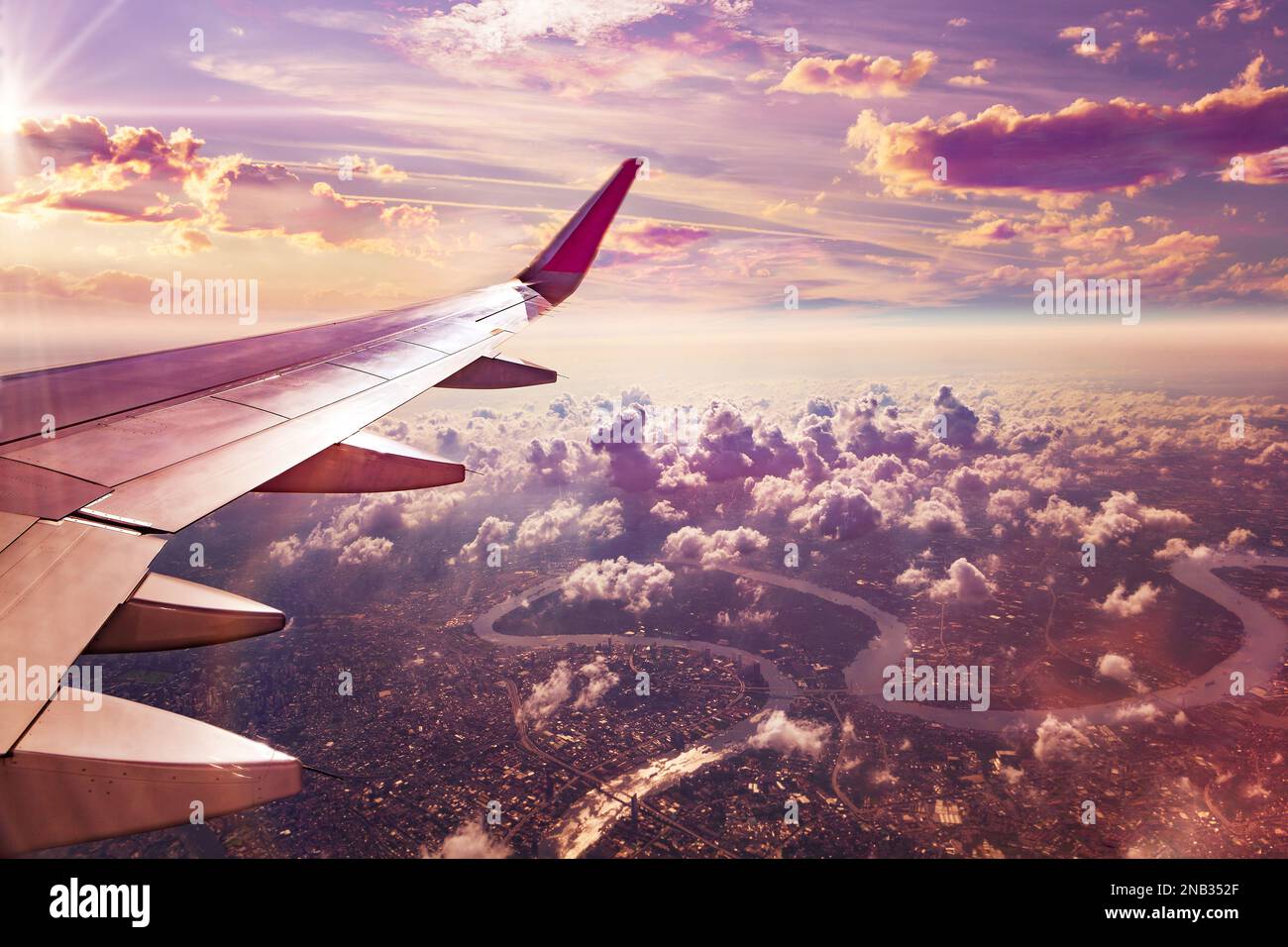 Concept of airplane travel. Flying above the city. Scenery sunset ...