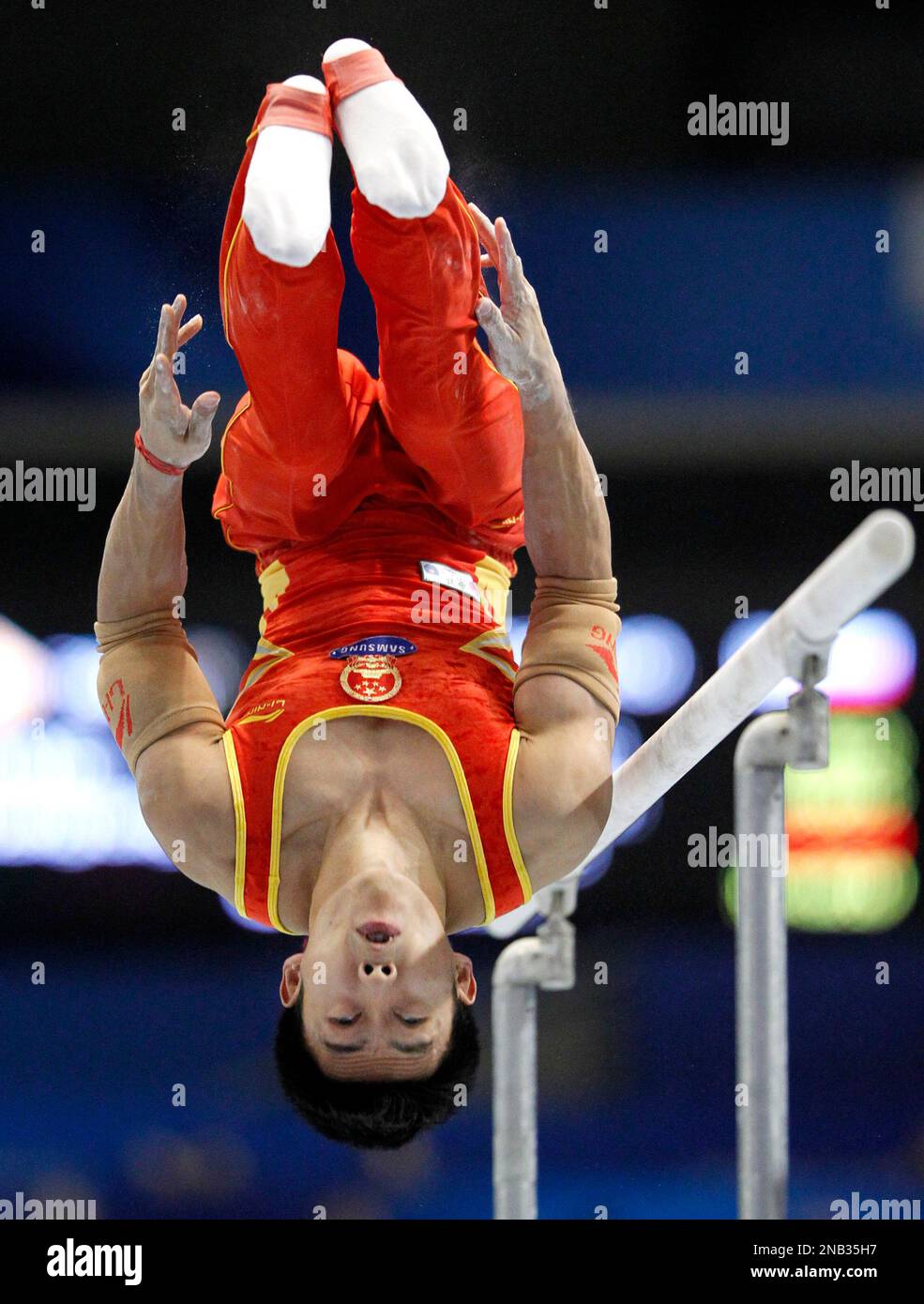 China's Teng Haibin performs on the parallel bars during the men's team ...