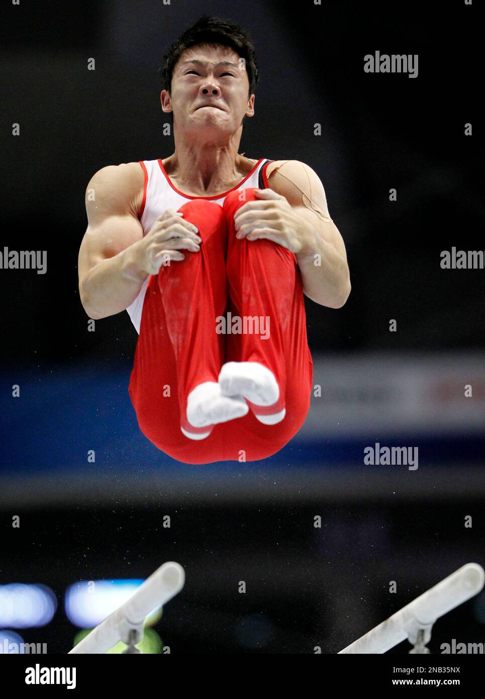 South Korea's Kim Seungil performs on the parallel bars during the men's team final at the ...