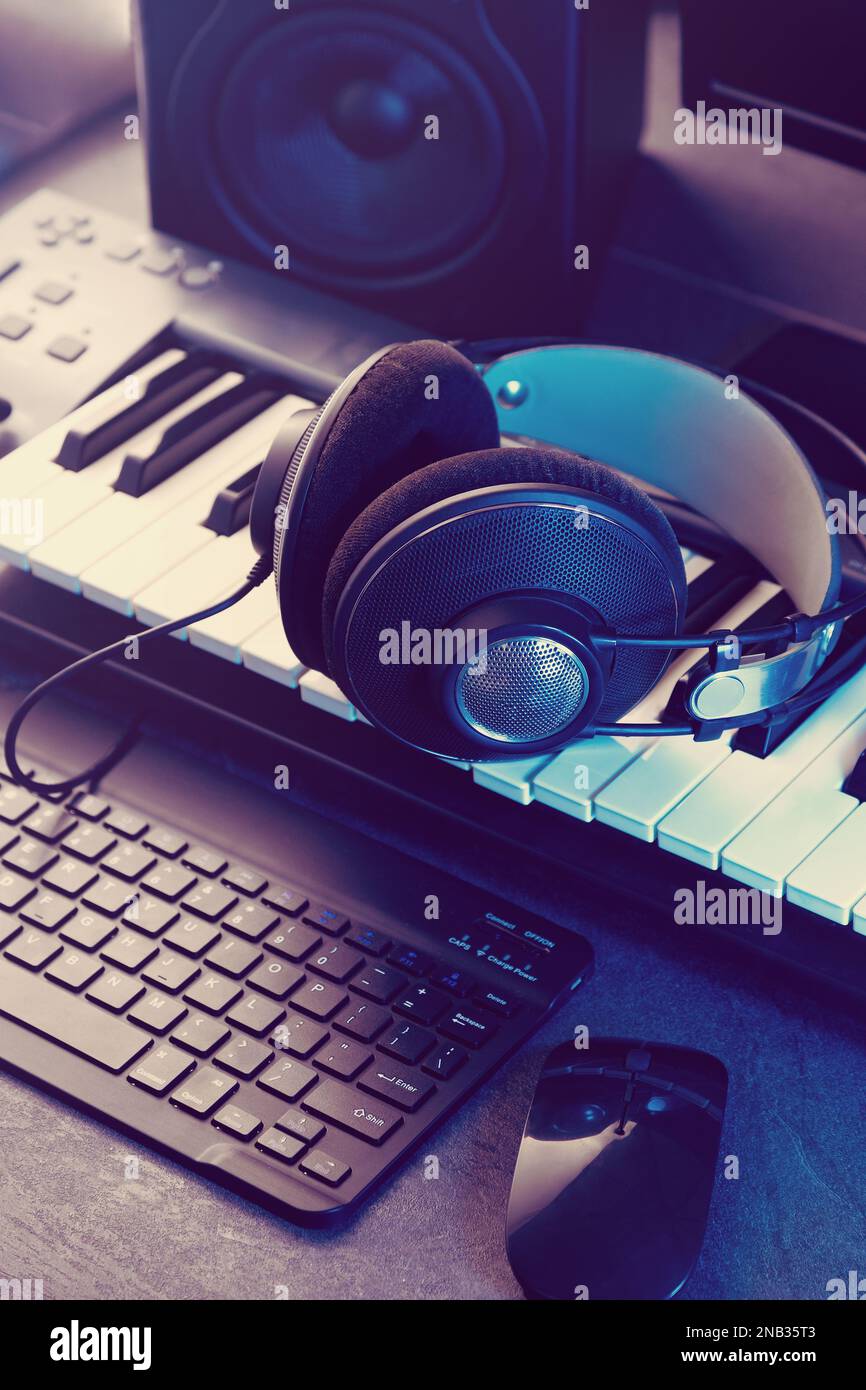 Keyboard or synthesizer with headphones and sound card. Computer ...