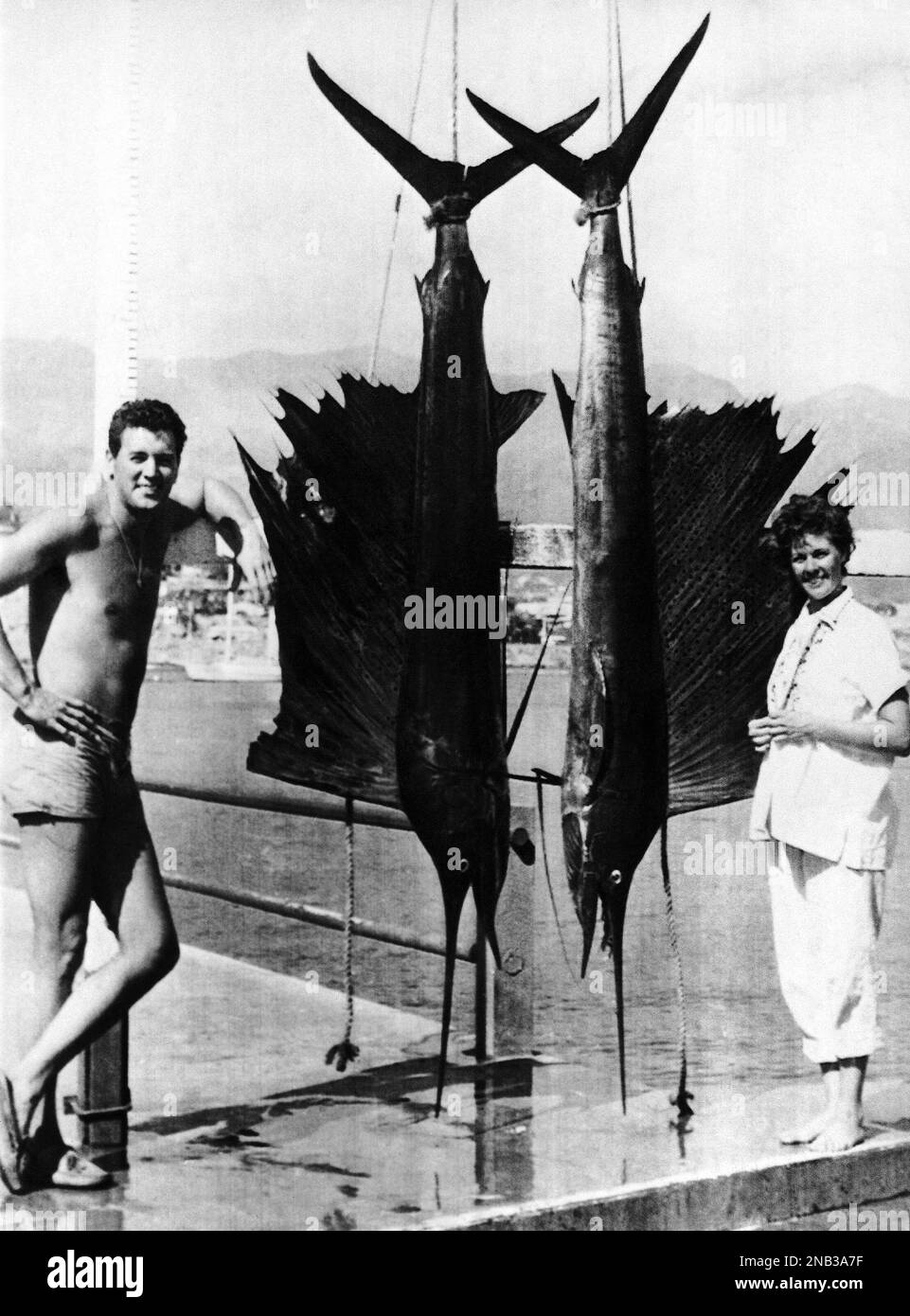 American actor Rock Hudson poses with his wife Phyllis Gates next to ...
