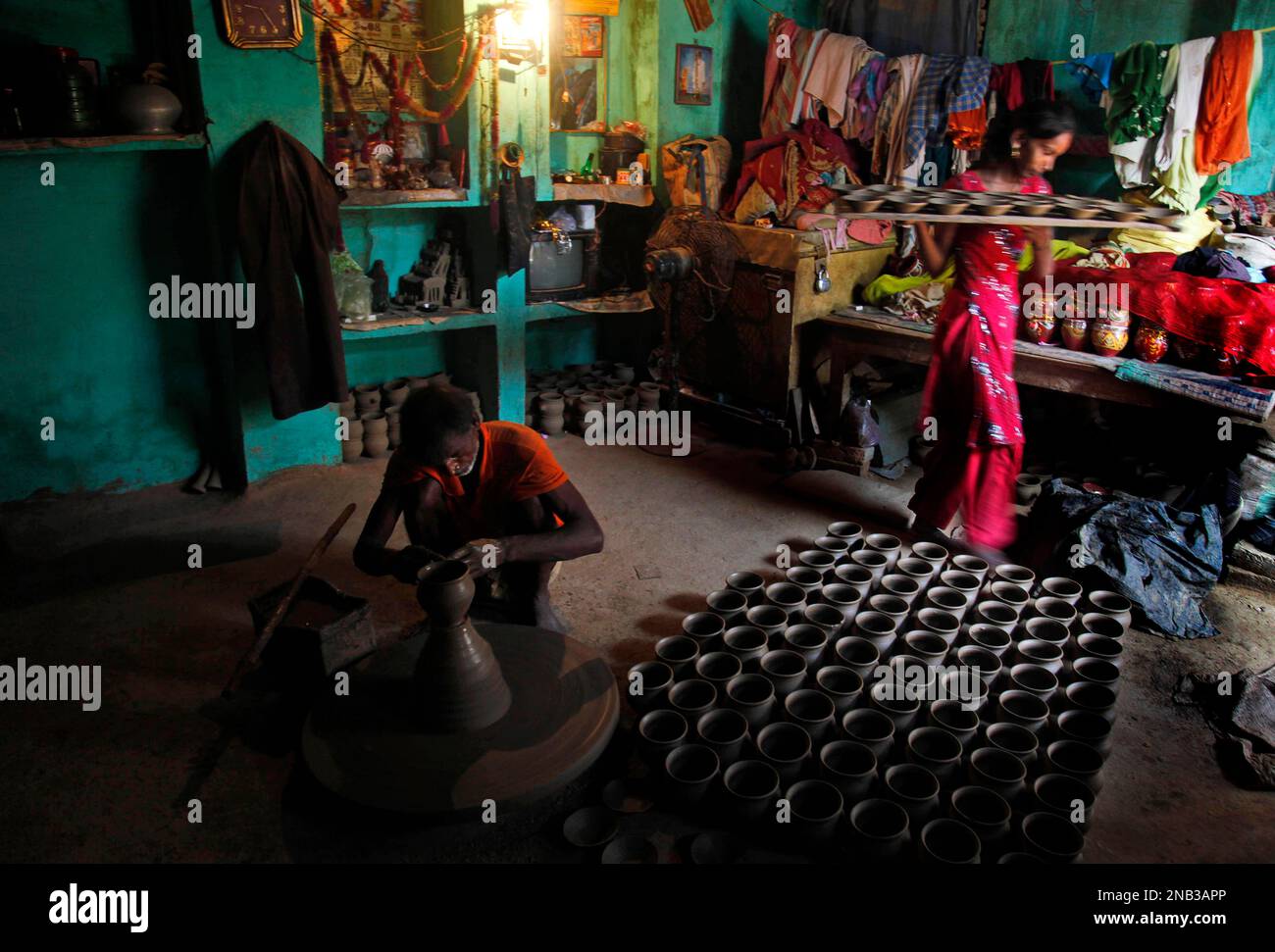 An Indian potter makes earthen lamps for the upcoming Diwali festival ...