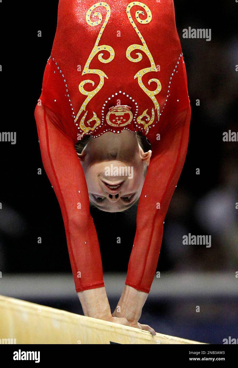 China's Tan Sixin performs on the balance beam during the women's team ...