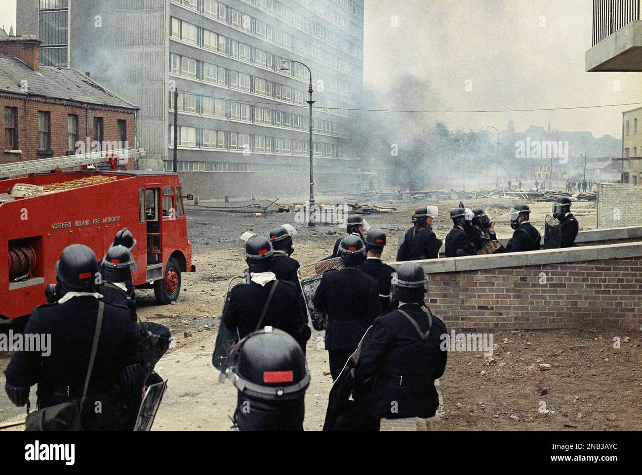 Riot police wearing helmets, carrying shields and supported by armored ...