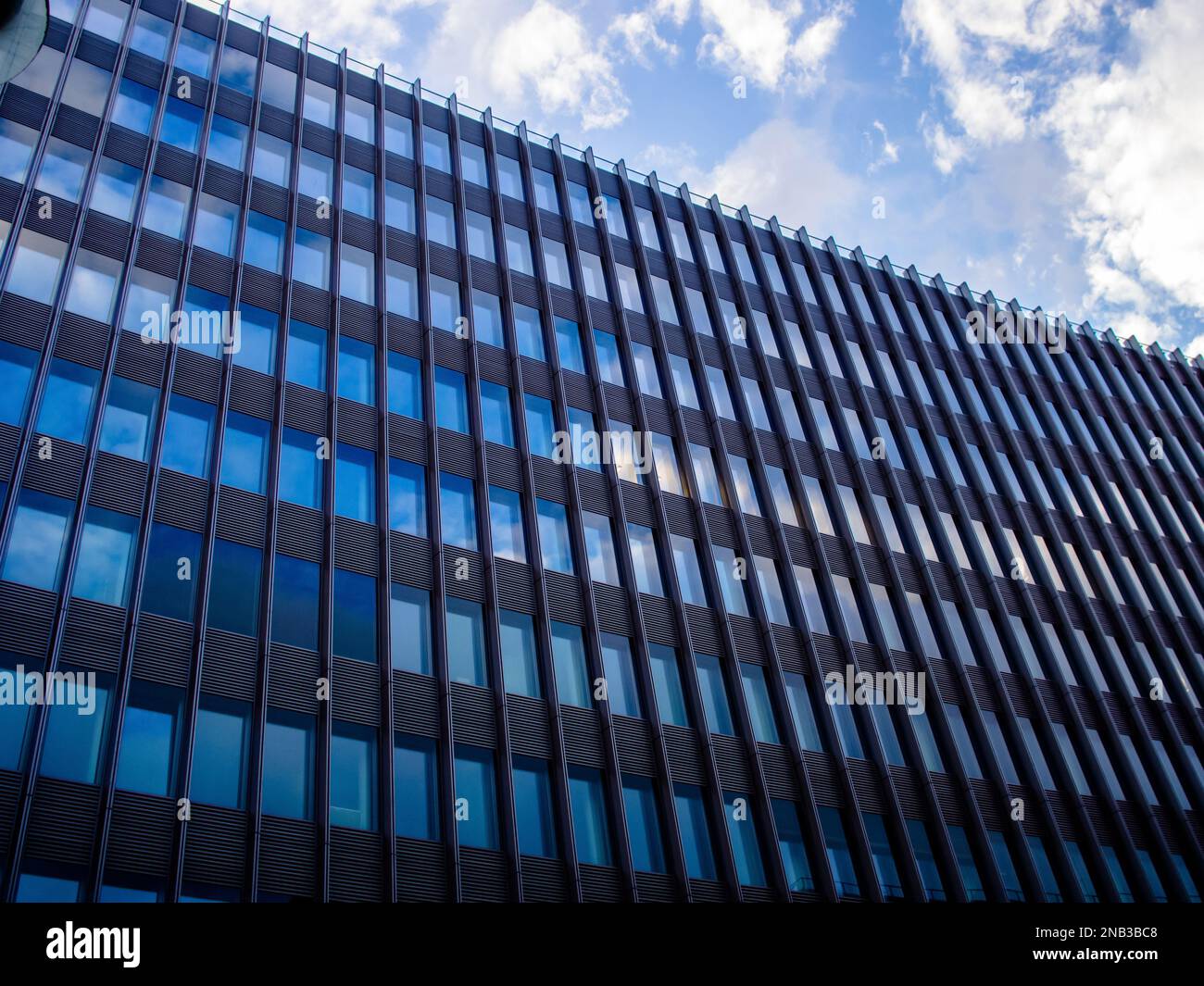 The exterior of a beautiful modern building with glass windows in ...