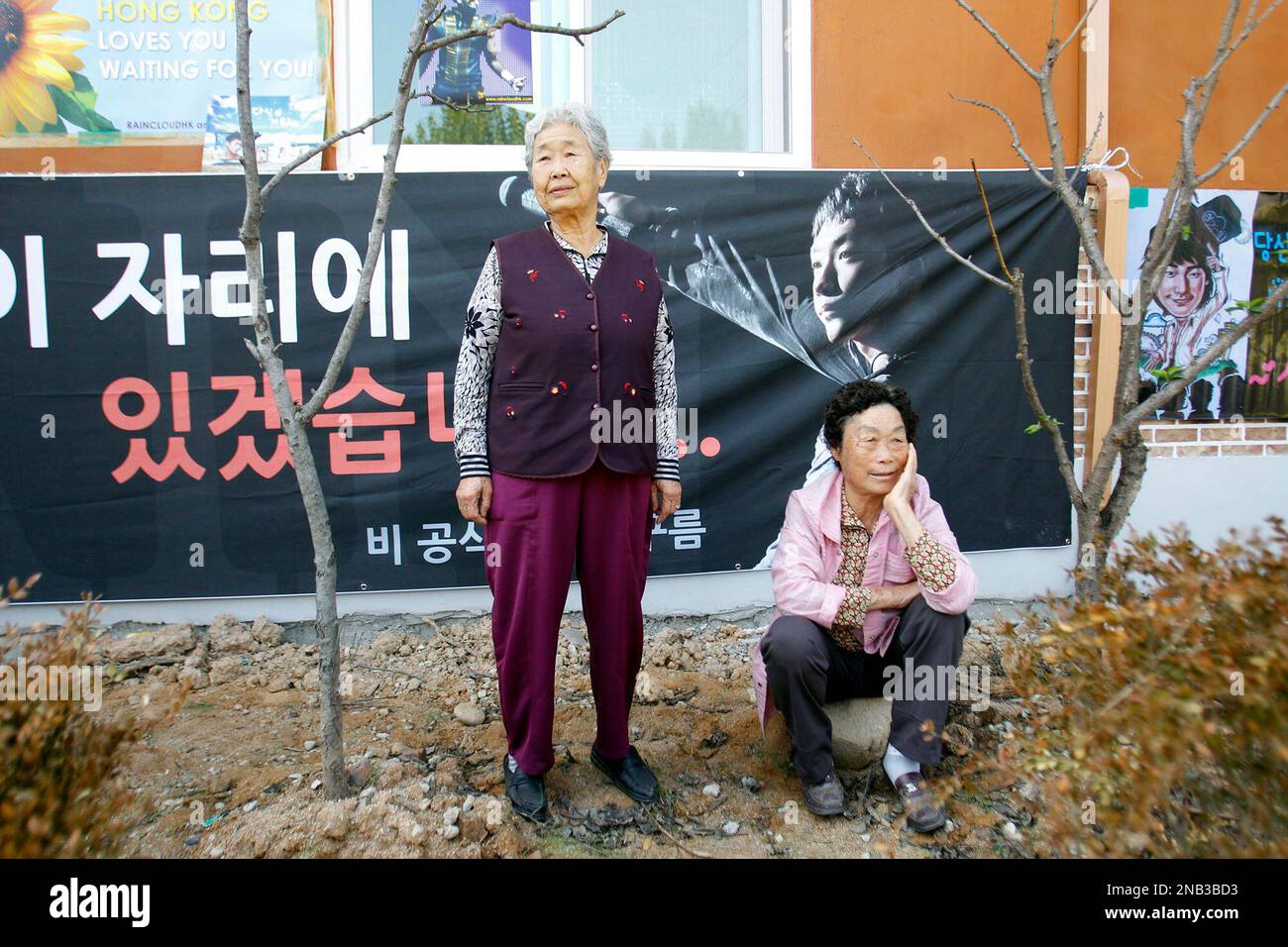 Local elderly women wait for South Korean pop singer Rain before the 29 ...