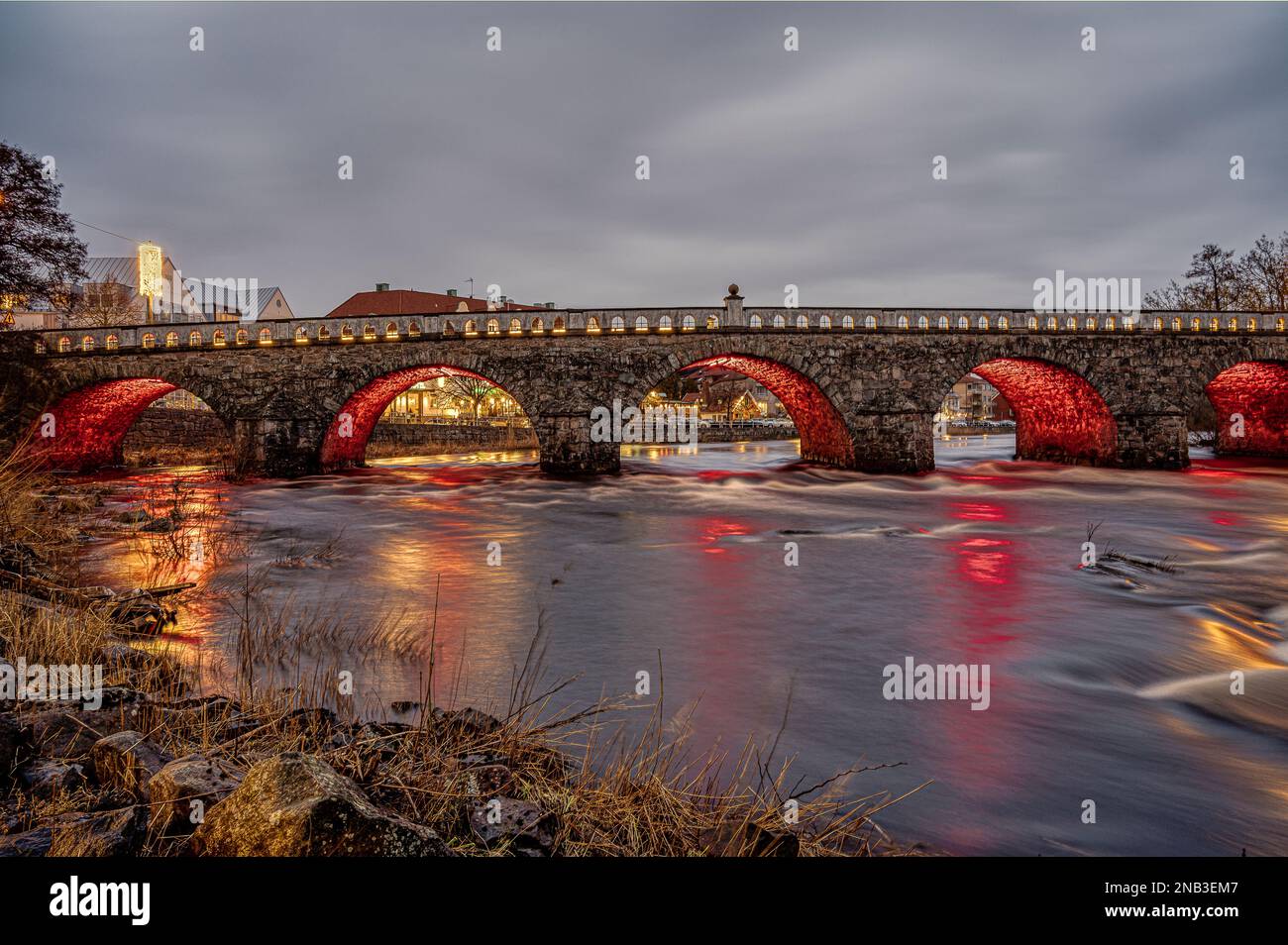 red light under the arches of Tullbron, an ancient stone bridge in ...