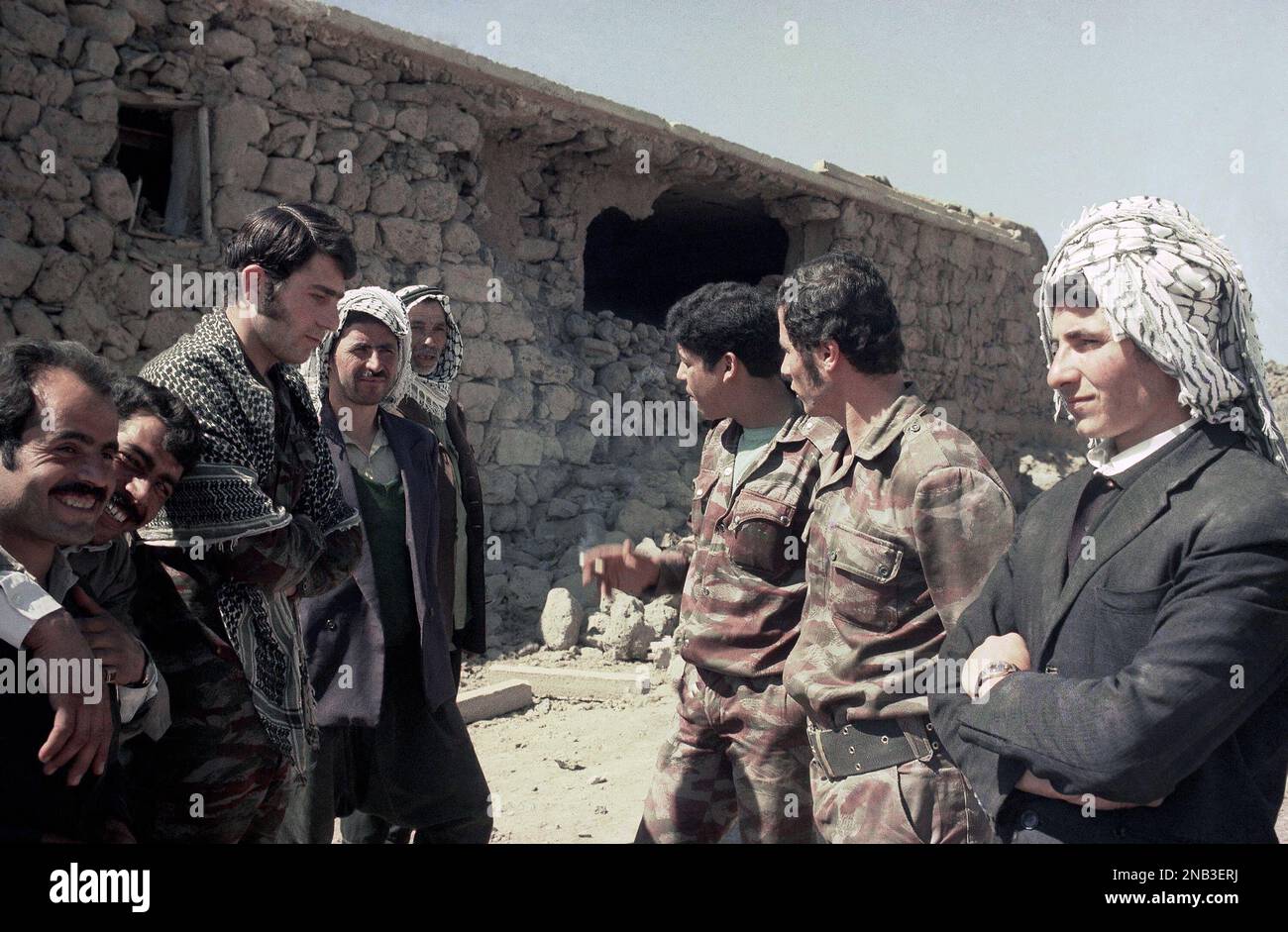 Syrian soldiers chat with villagers at Deir el Addis in Syria, June ...