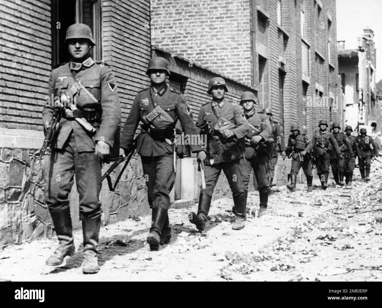 Nazi soldiers are advancing in a Belgian town on May 21, 1940, to ...