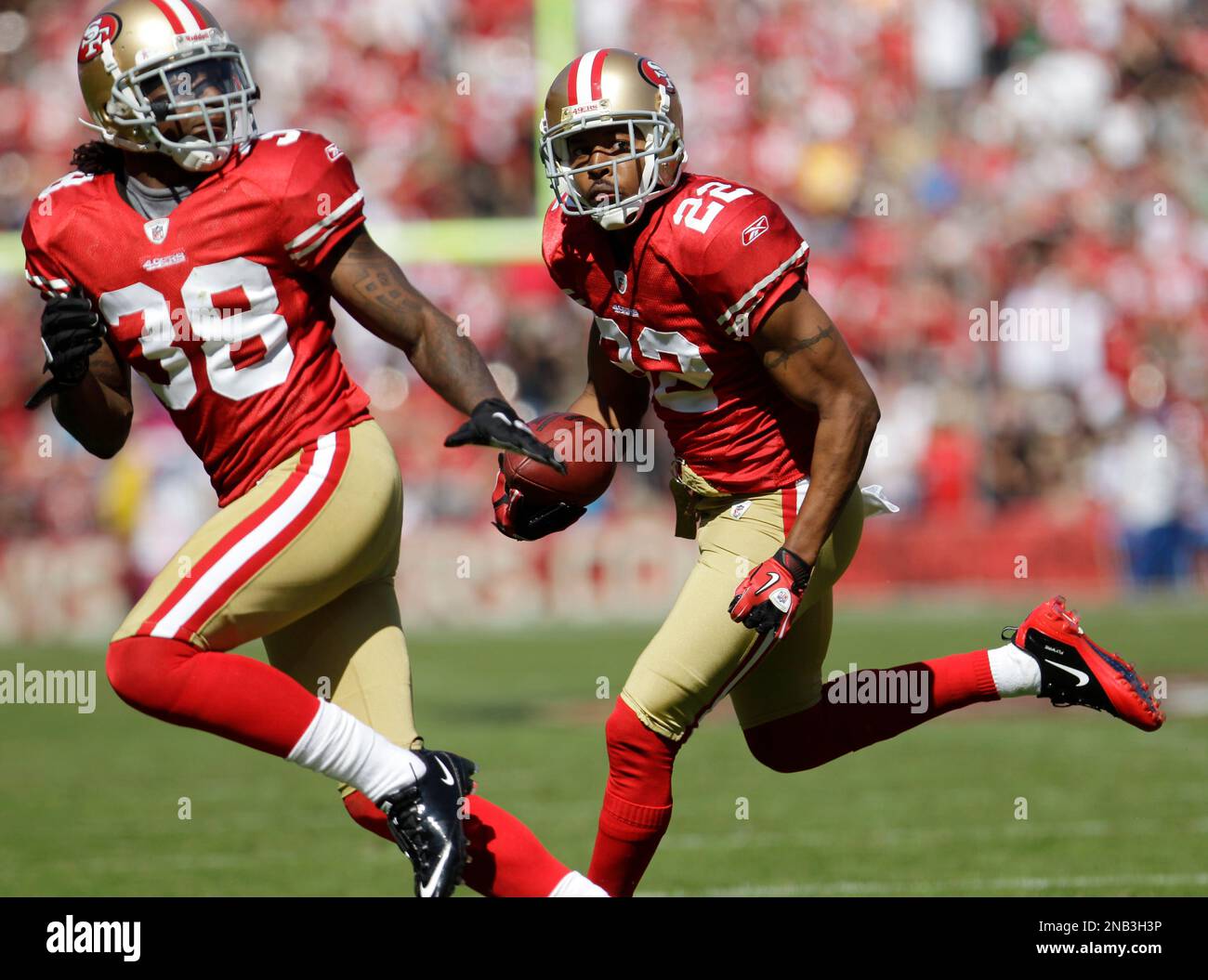 San Francisco 49ers cornerback Carlos Rogers, right, runs for a ...