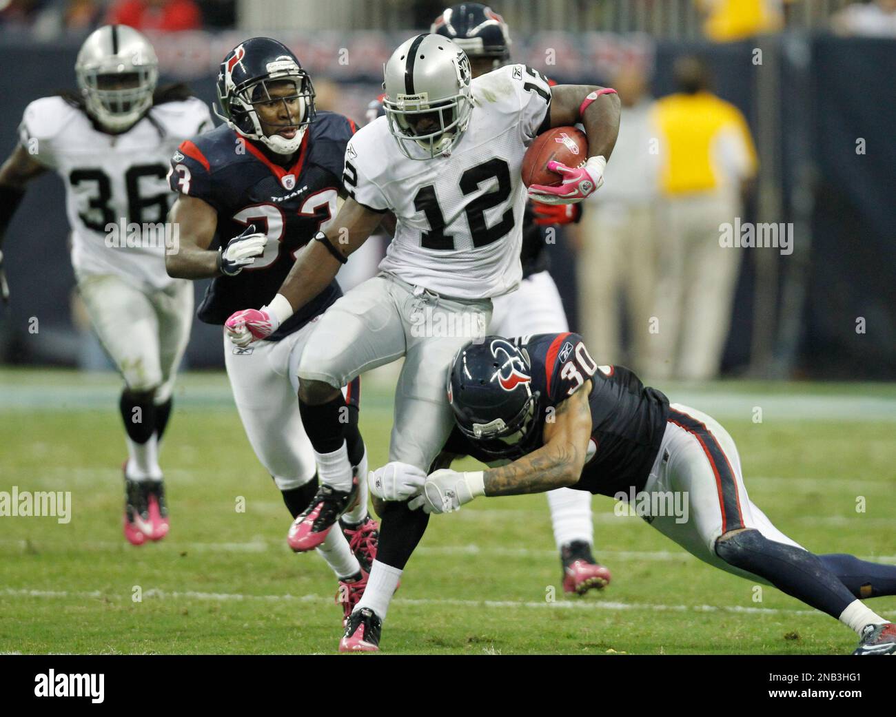Oakland Raiders wide receiver Jacoby Ford (12) chased by Houston Texans ...