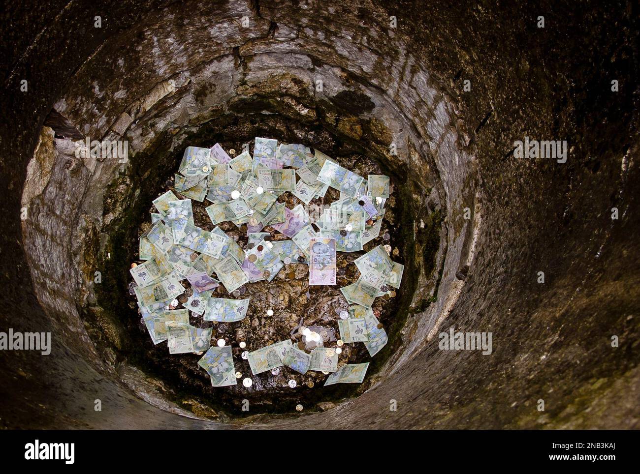 Banknotes and coins are seen in an well at the Gothic Bran Castle ...