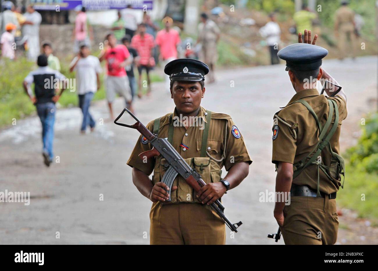 Sri Lankan police officers stand guard following a shootout on the ...