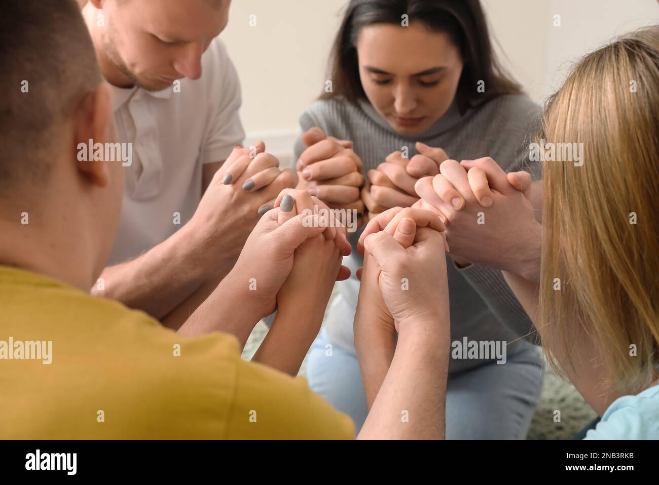 Group of people praying home christian hi-res stock photography and ...