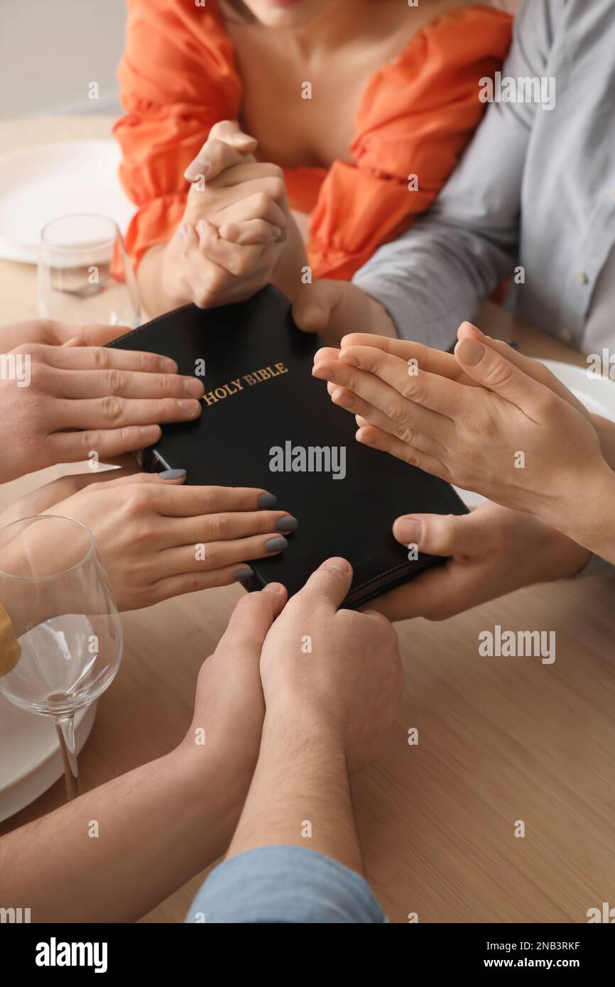 Young family praying sitting table hi-res stock photography and images ...