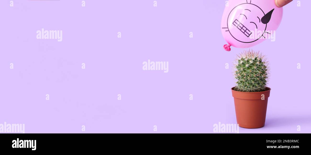 Cactus and air balloon with drawn stressed emoticon on lilac background ...