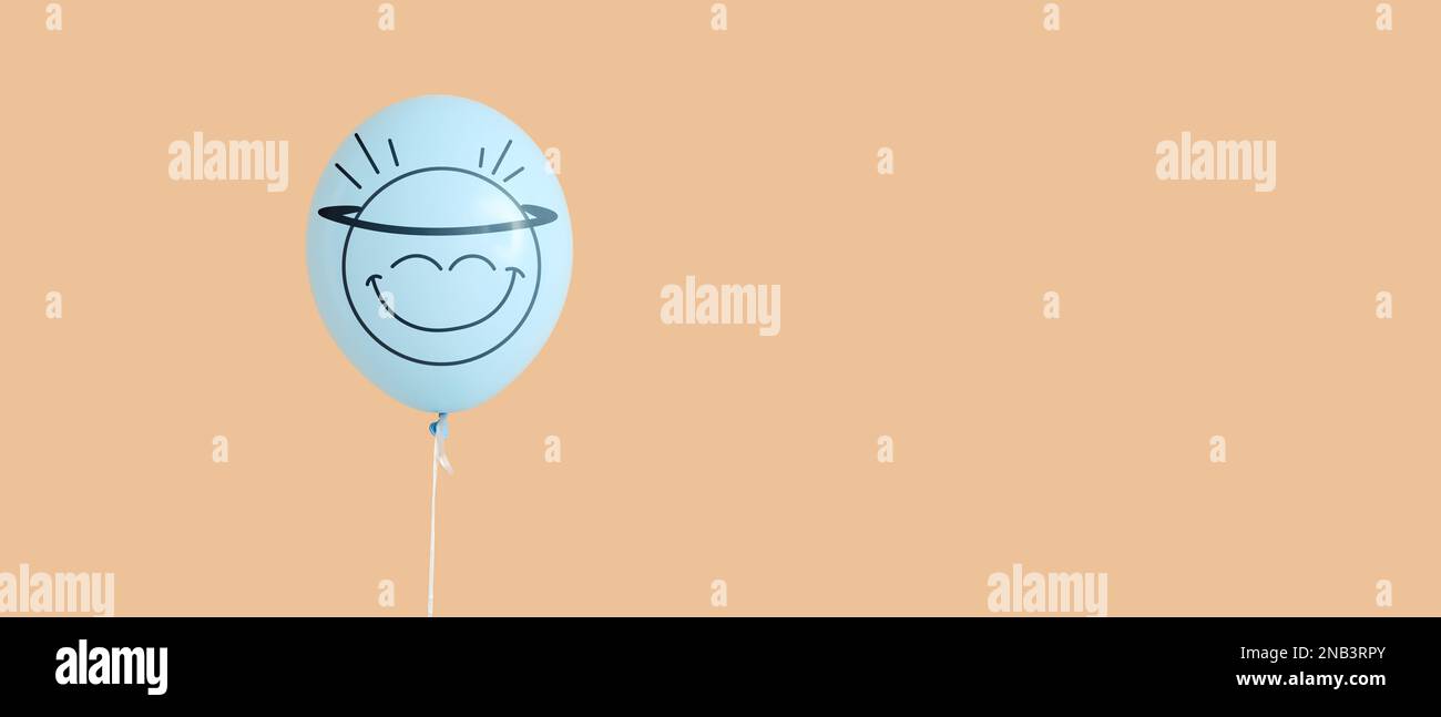 Air balloon with drawn happy emoticon on beige background with space ...