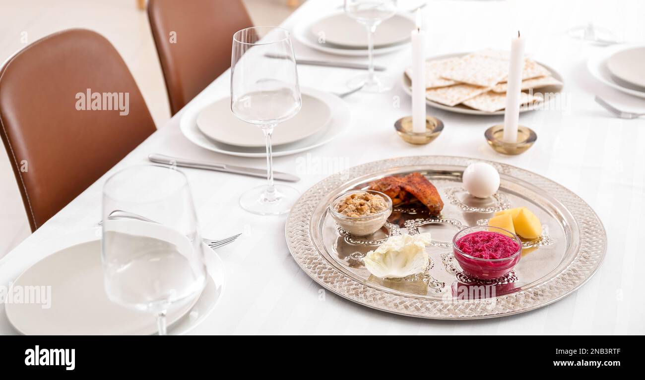 Passover Seder plate with traditional food on served table in dining ...