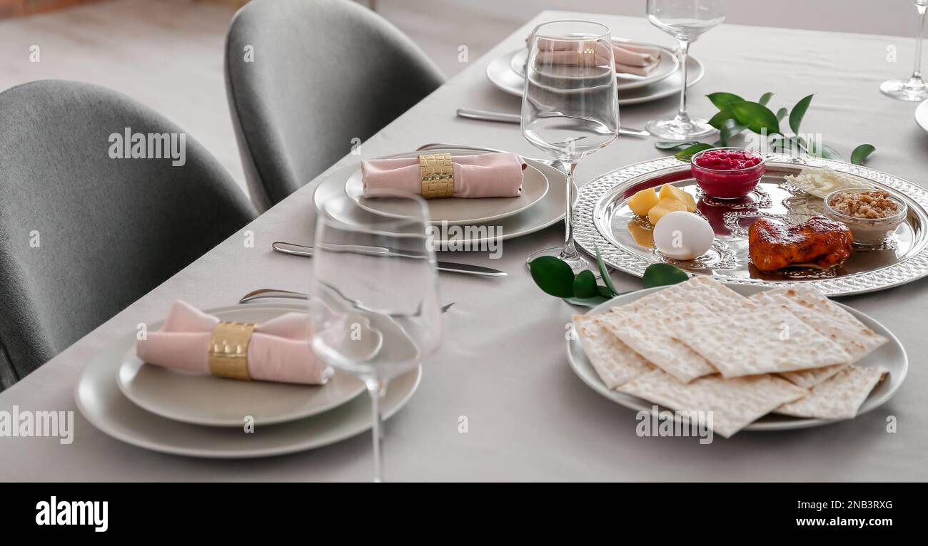 Passover Seder plate with traditional food on served table in dining ...