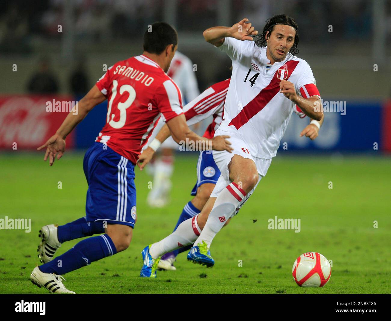 Peru's Claudio Pizarro, right, is chased by Paraguay's Miguel Samudio ...