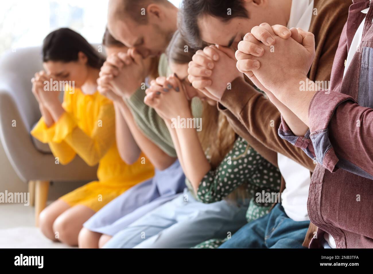 Group of people praying with Holy Bible on floor, closeup Stock Photo ...