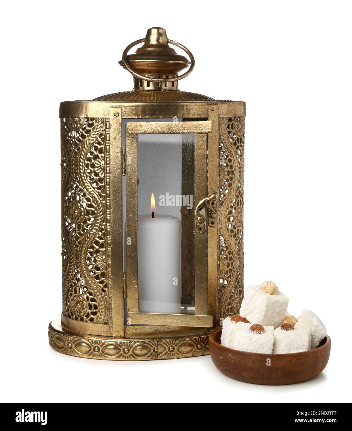 Muslim lantern with burning candle and sweets for Ramadan on white ...