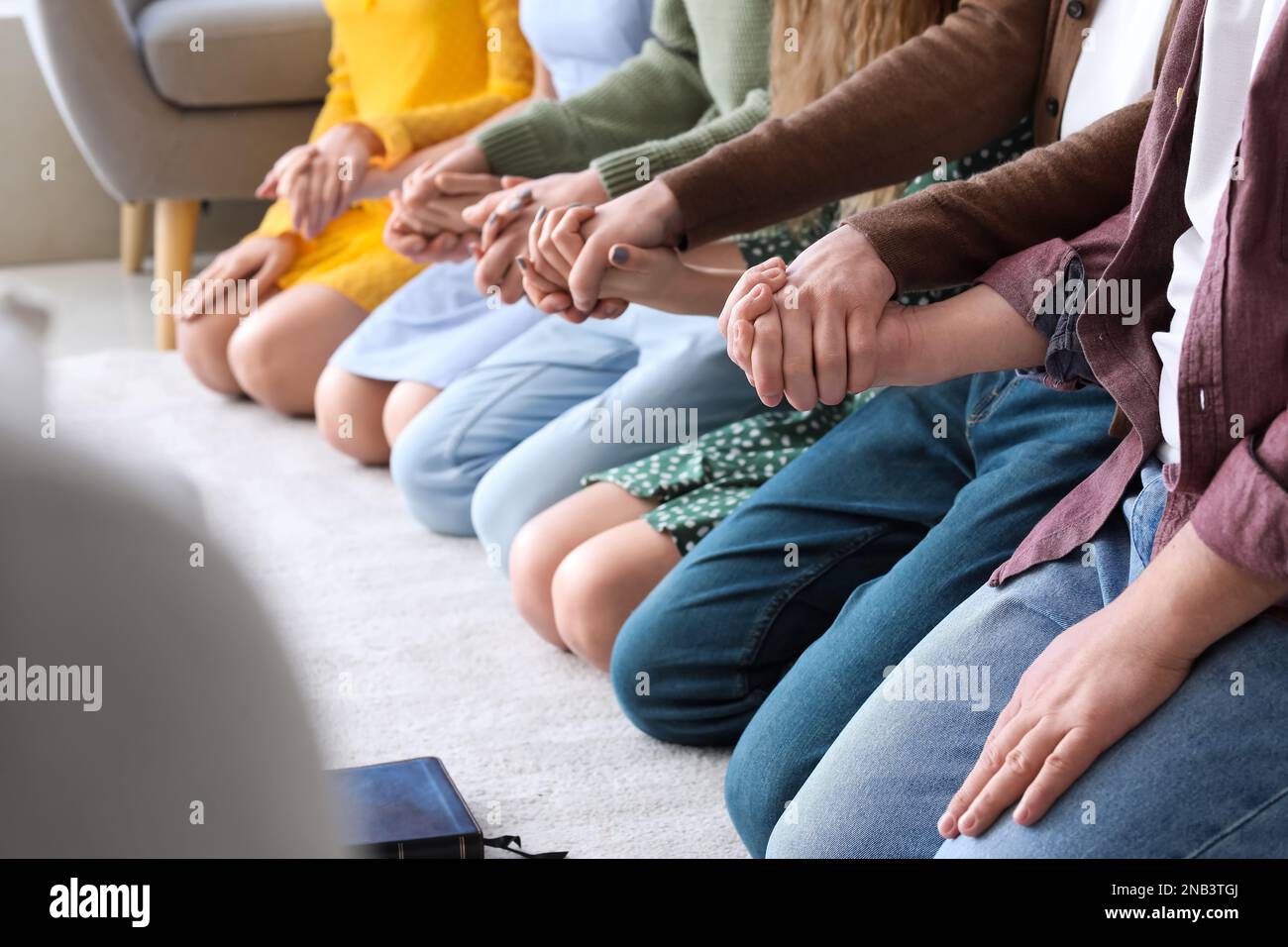 Group of people praying with Holy Bible on floor, closeup Stock Photo ...