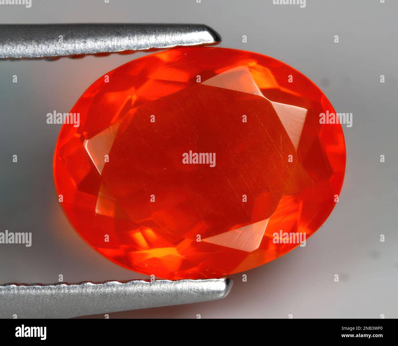 Natural gemstone fire opal on gray background Stock Photo - Alamy