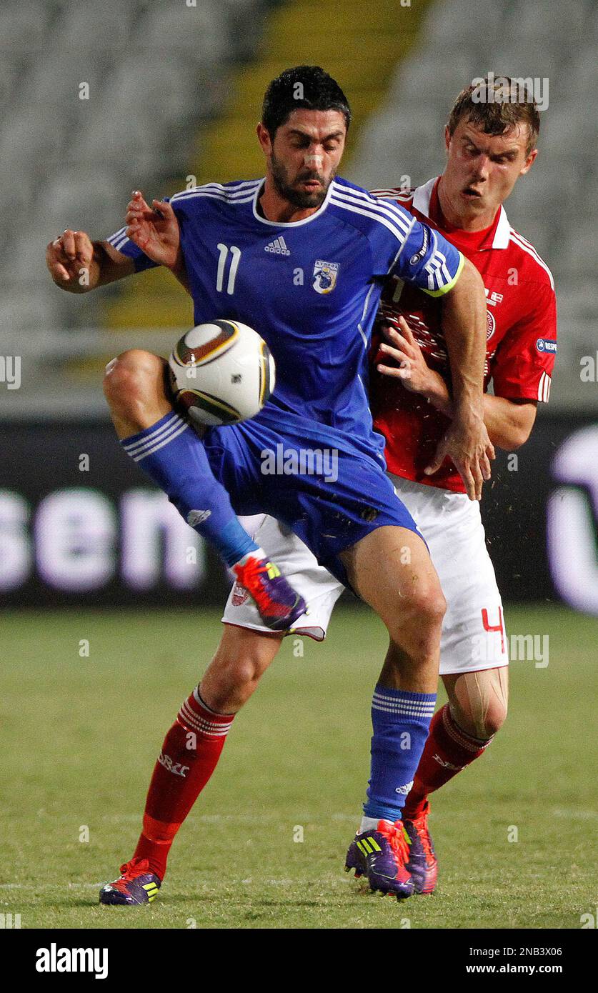 Michael Constantinou, front, of Cyprus fights for the ball with Andreas ...